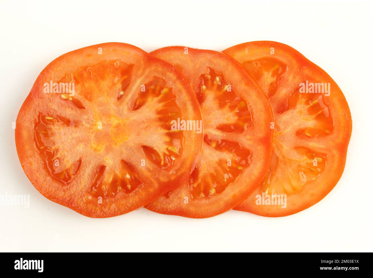 Three tomato slices isolated on white background Stock Photo - Alamy