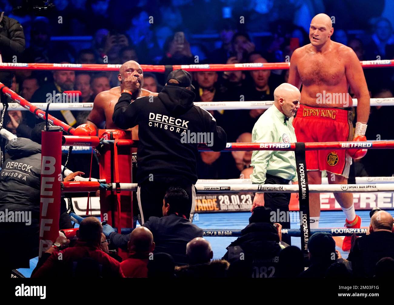 Derek Chisora is checked over by a member of his team as the referee ...