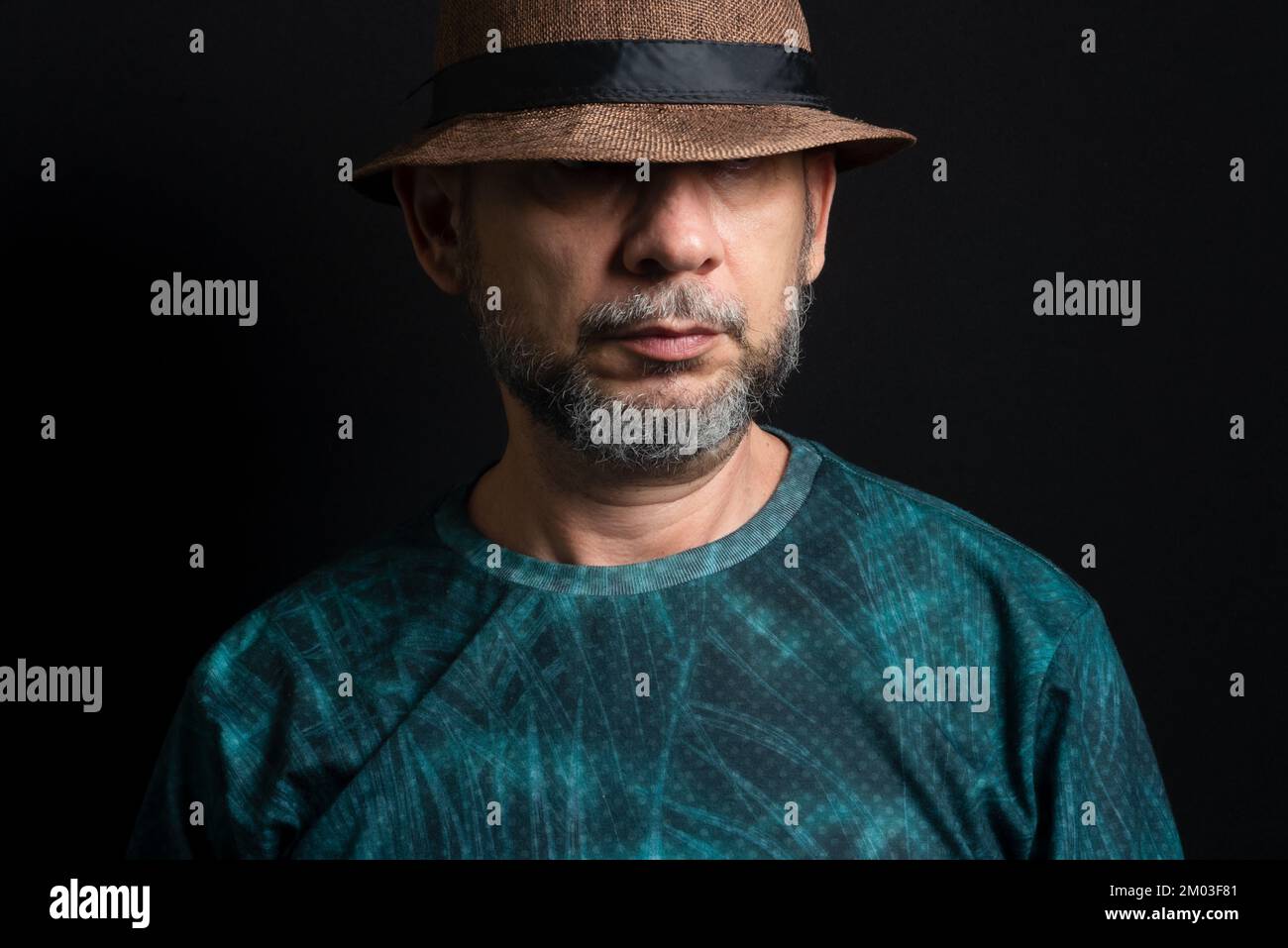 Bearded man wearing hat. Looking forward. Isolated on black background ...