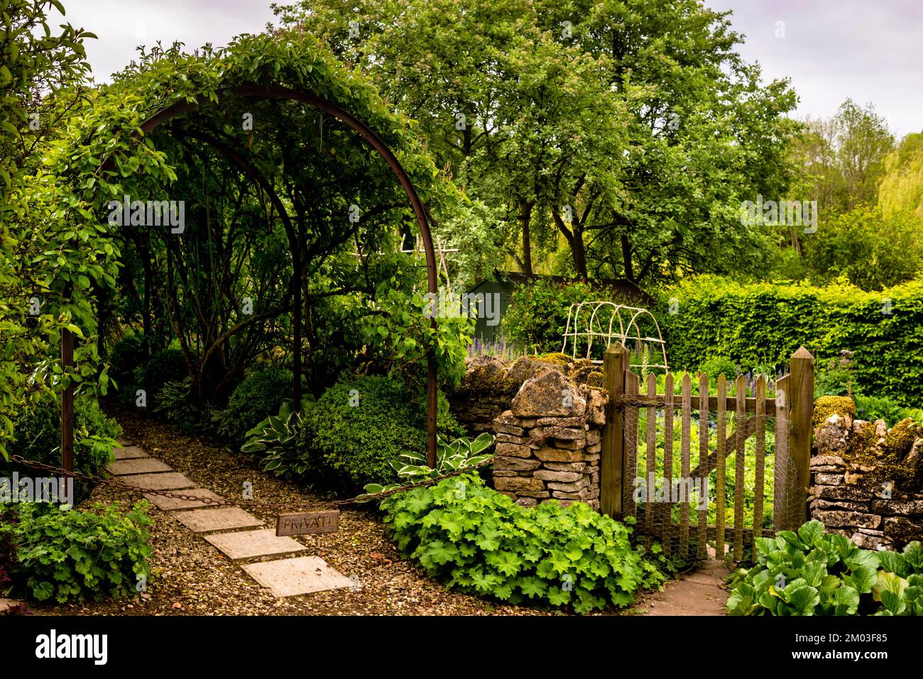 Trellis and gated garden beside the Cotswold Way public path in rural ... Trellis and gated garden beside the Cotswold Way public path in rural ...