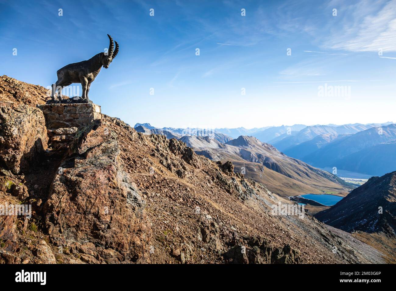 Ibex above Piz Nair mountain range with lake in the Alps, Engadine ...