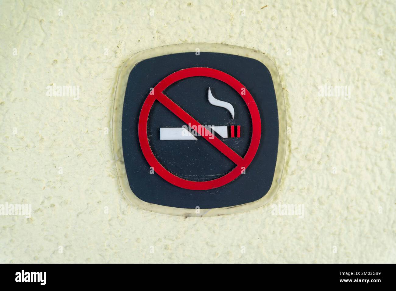 Destin, Florida- No smoking symbol signage on a painted textured wall ...