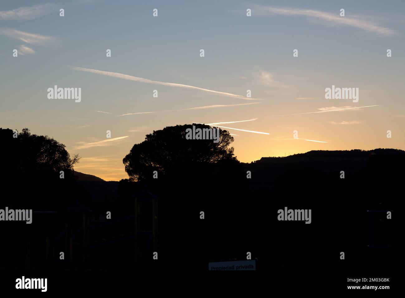 sky streaked by aircraft trails at dusk in the autumn season Stock ...