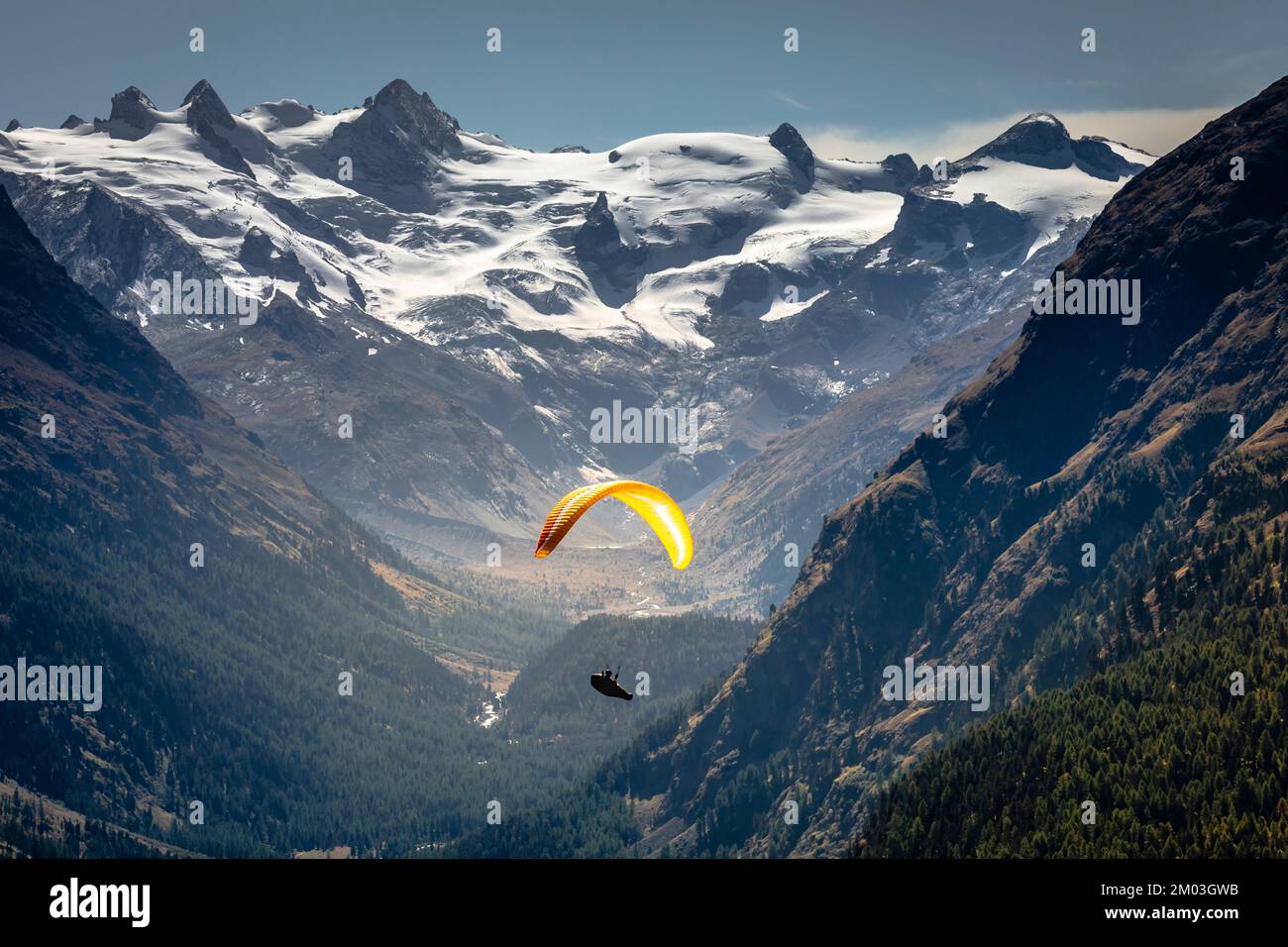 Paragliding above Bernina mountain range with glaciers in the Alps ...