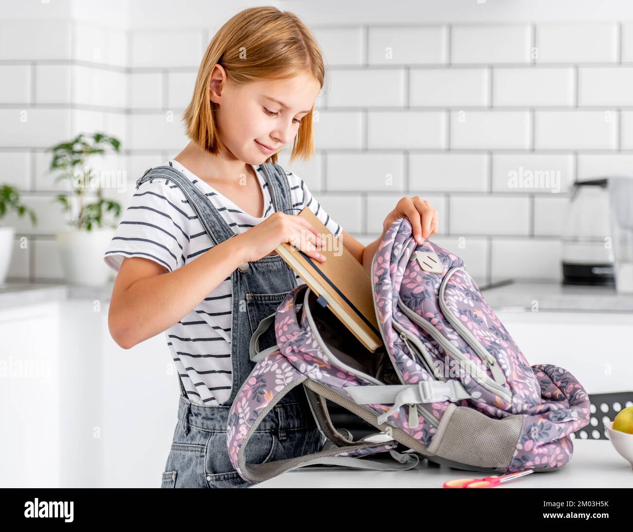 Girl preparing backpack Stock Photo - Alamy