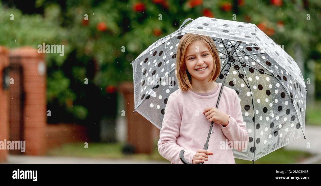 Preteen girl with umbrella Stock Photo - Alamy