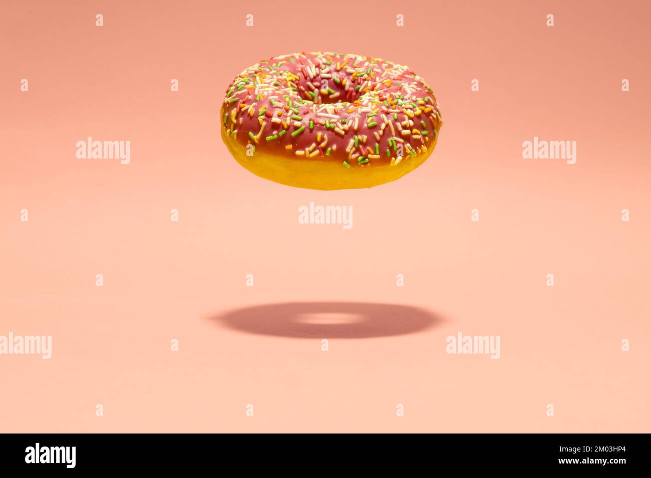 Flying pink donut hi-res stock photography and images - Alamy