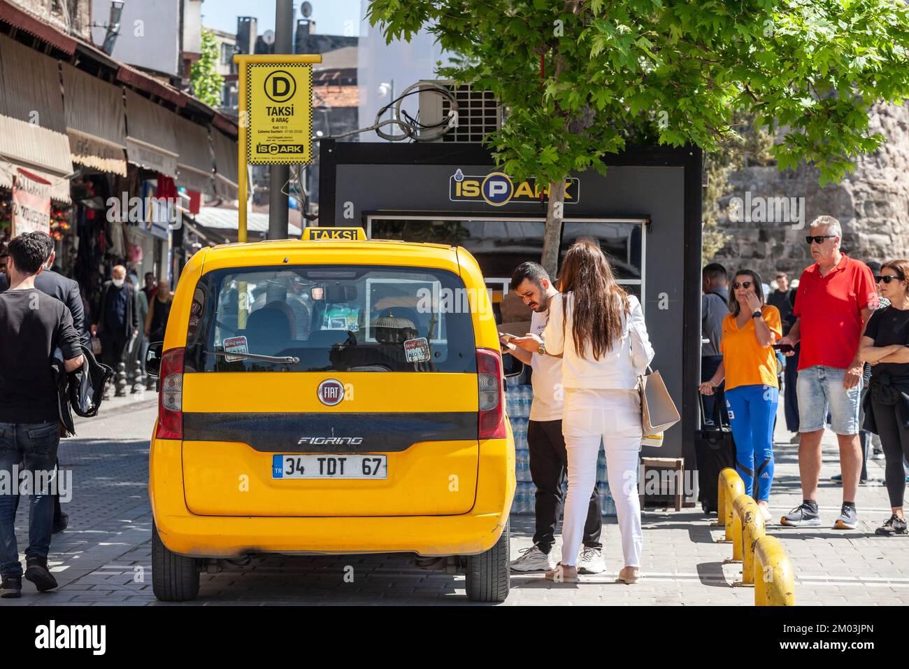 Picture of a taxi driver and clients ready to ride a taxi in the city ...