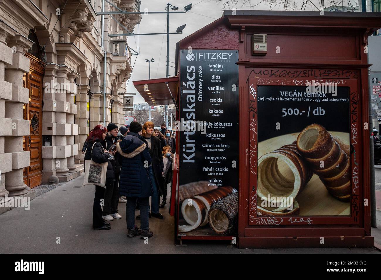 Picture of people waiting to buy kurtoskalacs. Kürtőskalács is a spit ...