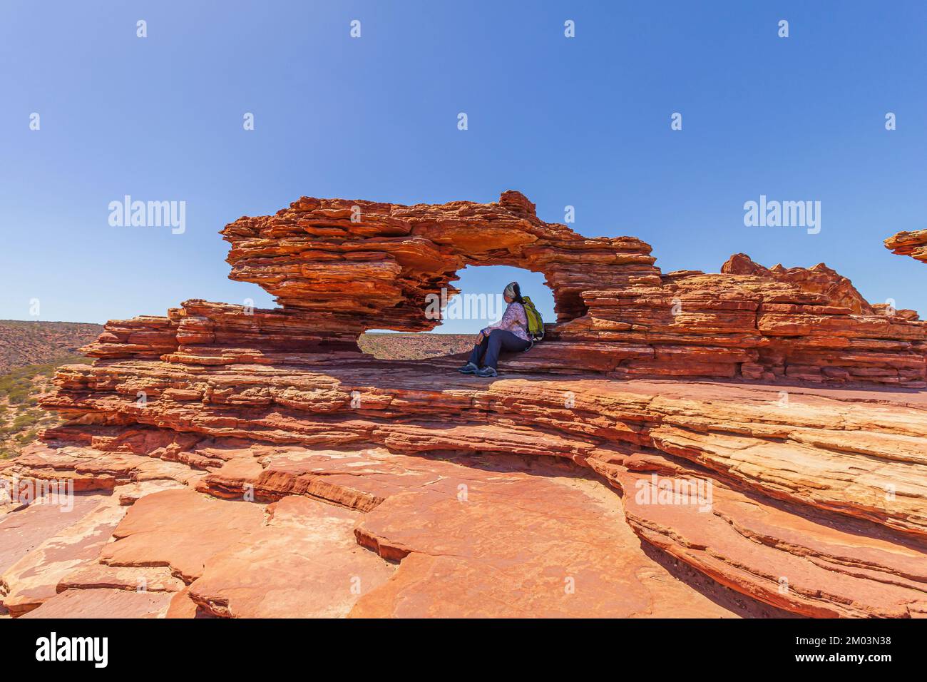 A woman hiker nature at formation called Nature Window which is a wind ...