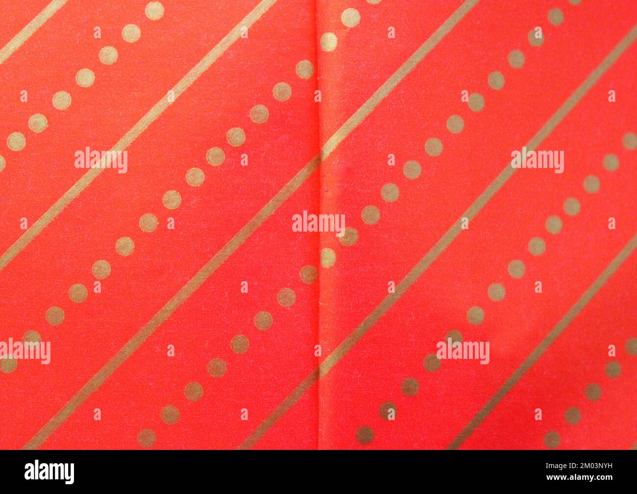 A Seam Between Two Pieces of Red and Gold Patterned Wrapping Paper ...
