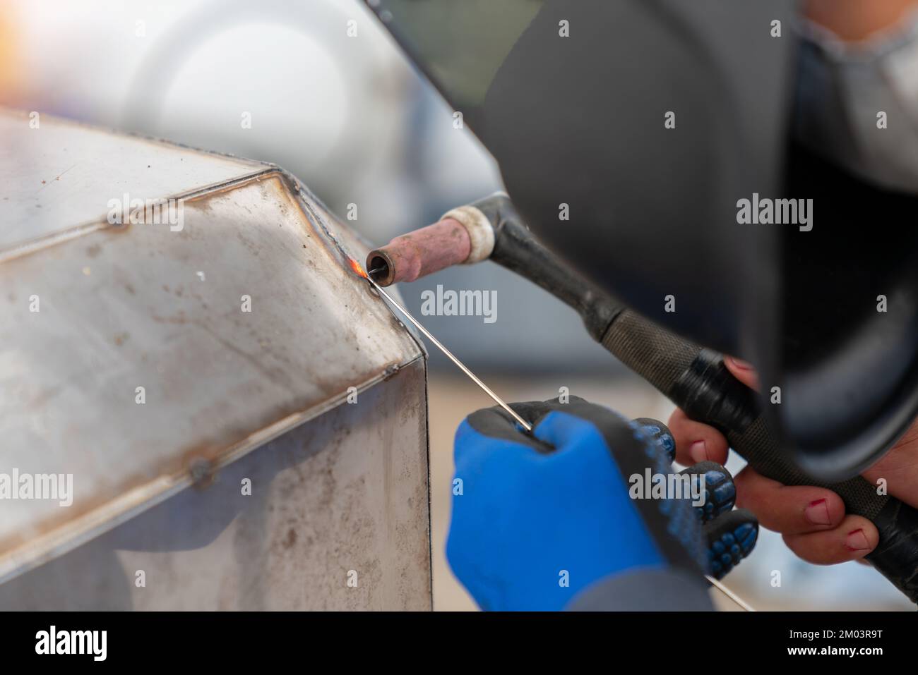 Welder ware blue gloves welding stainless steel tank at industry Stock ...