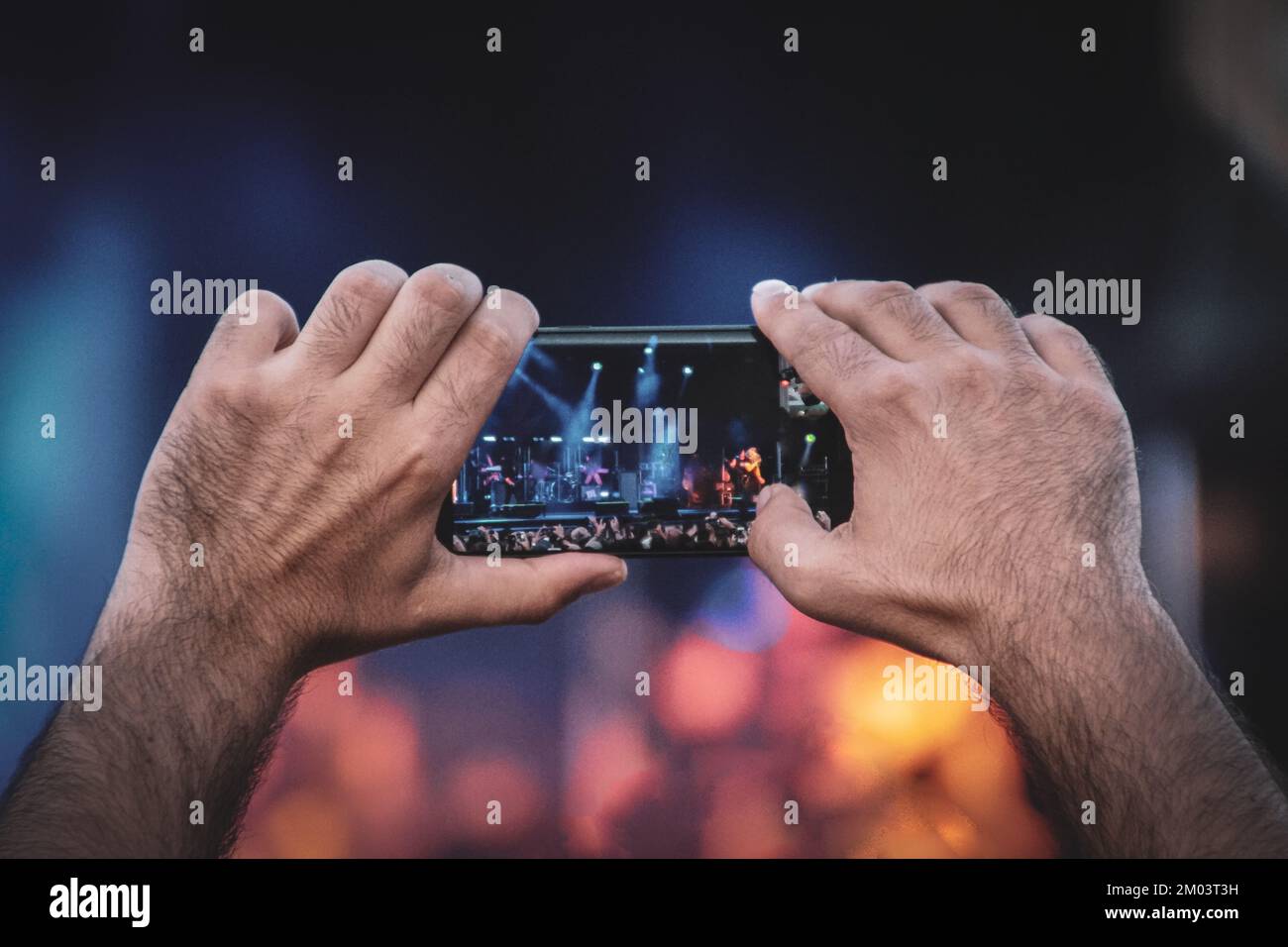 Man hands holding camera filming hi-res stock photography and images ...