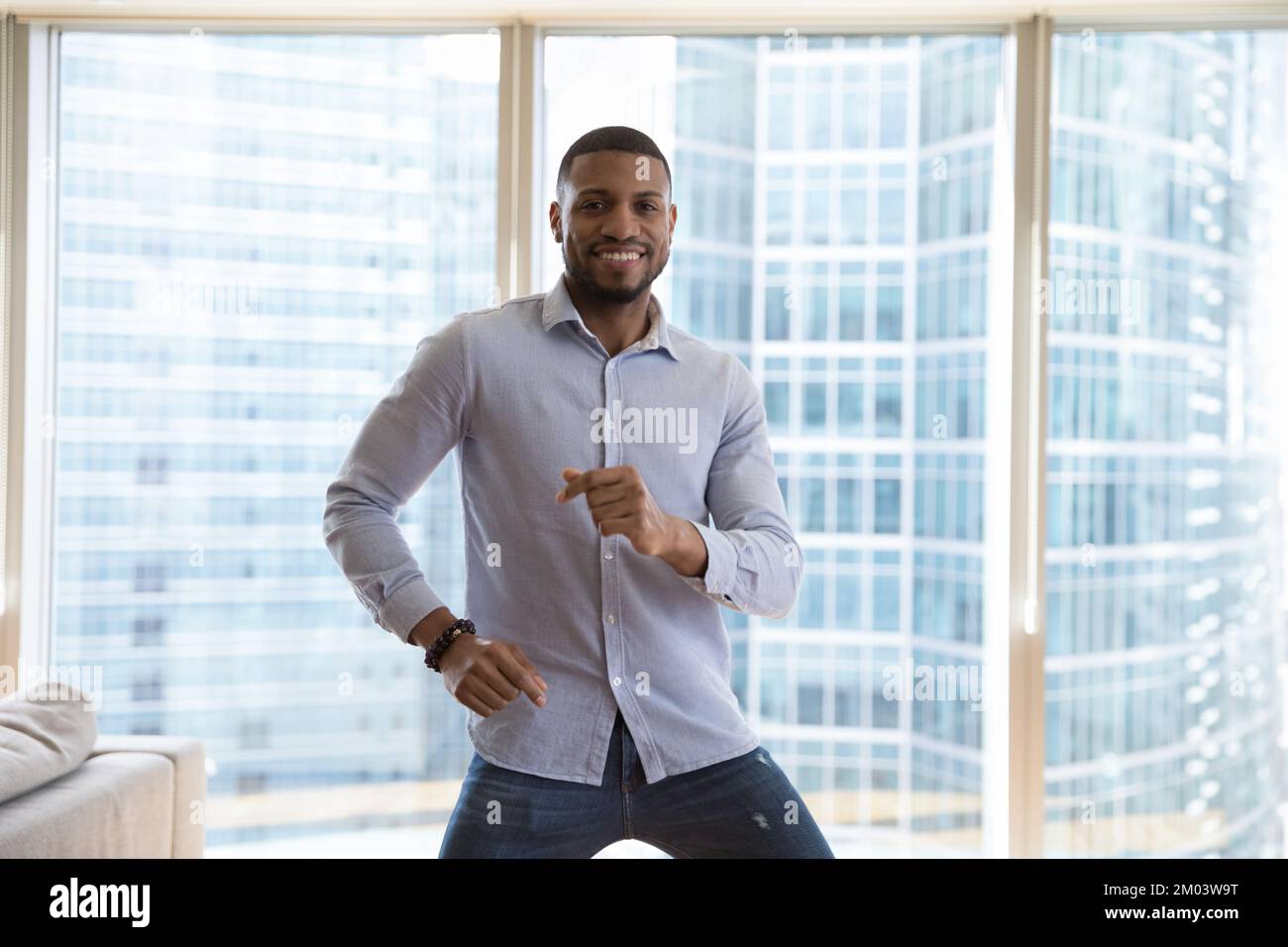 Happy handsome young African man having fun indoors Stock Photo - Alamy
