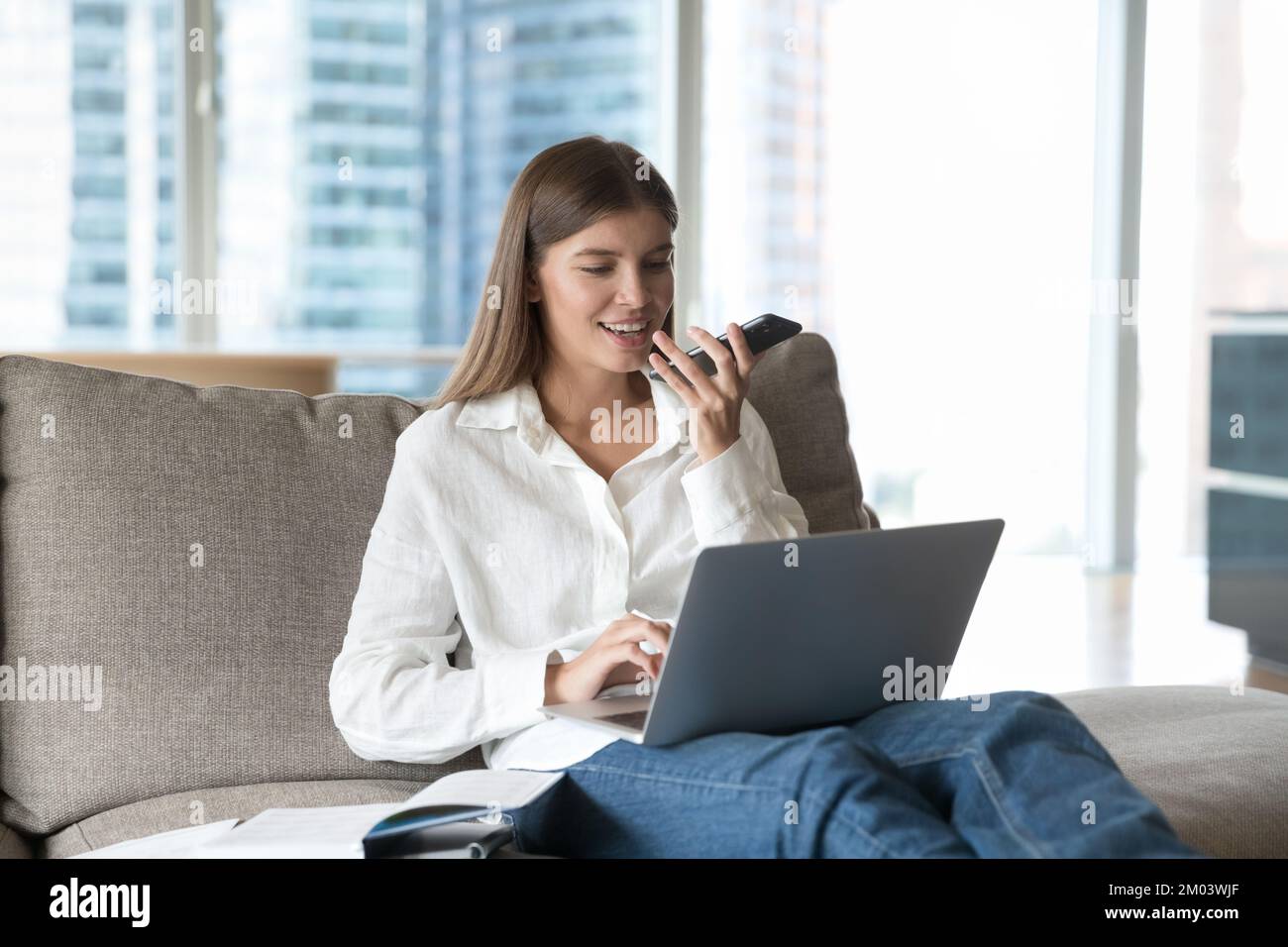 Busy confident positive freelance employee woman resting on home sofa ...