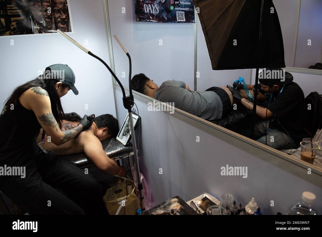 Bangkok, Thailand. 3rd Dec, 2022. A tattoo artist puts tattoos on the ...