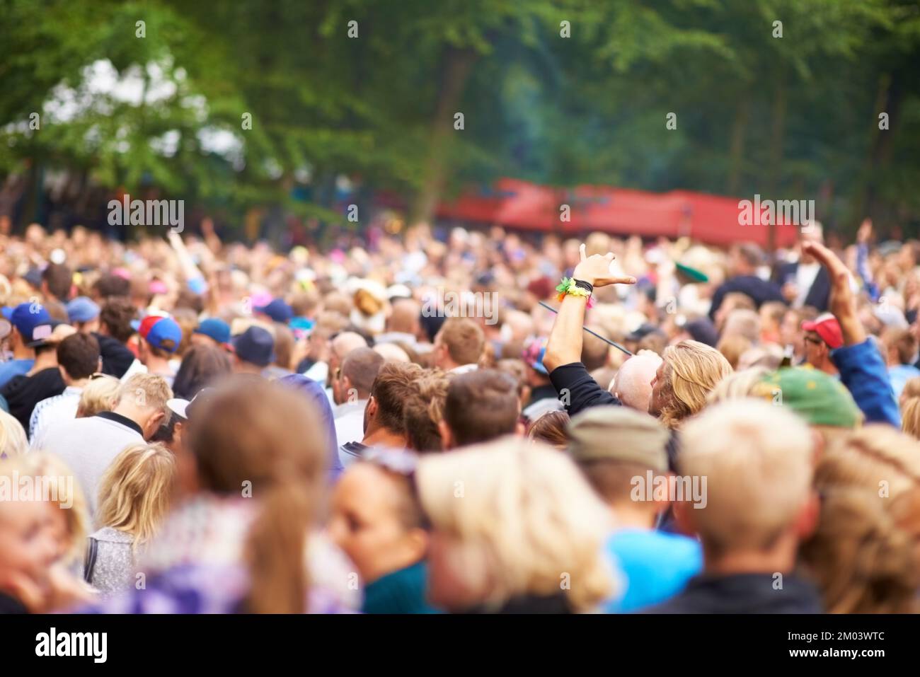 Cheering crowd. a large crowd standing outside and looking towards a ...