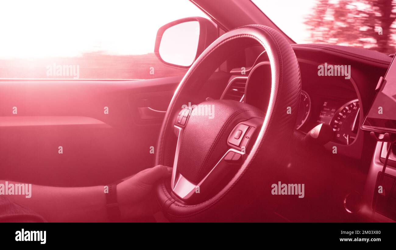 Color of year 2023 Viva Magenta. Image with car steering wheel is toned ...