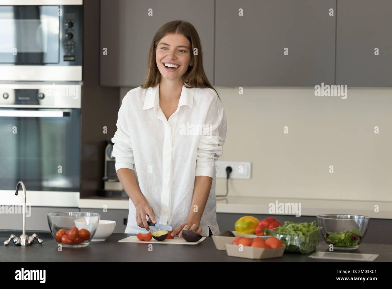 Cheerful beautiful chef girl cooking healthy meal for dinner Stock ...