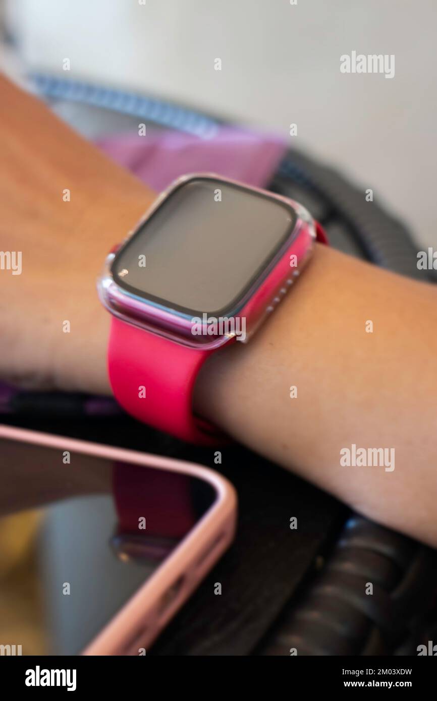 Red smart watch with a blank black screen on left hand, stock photo ...