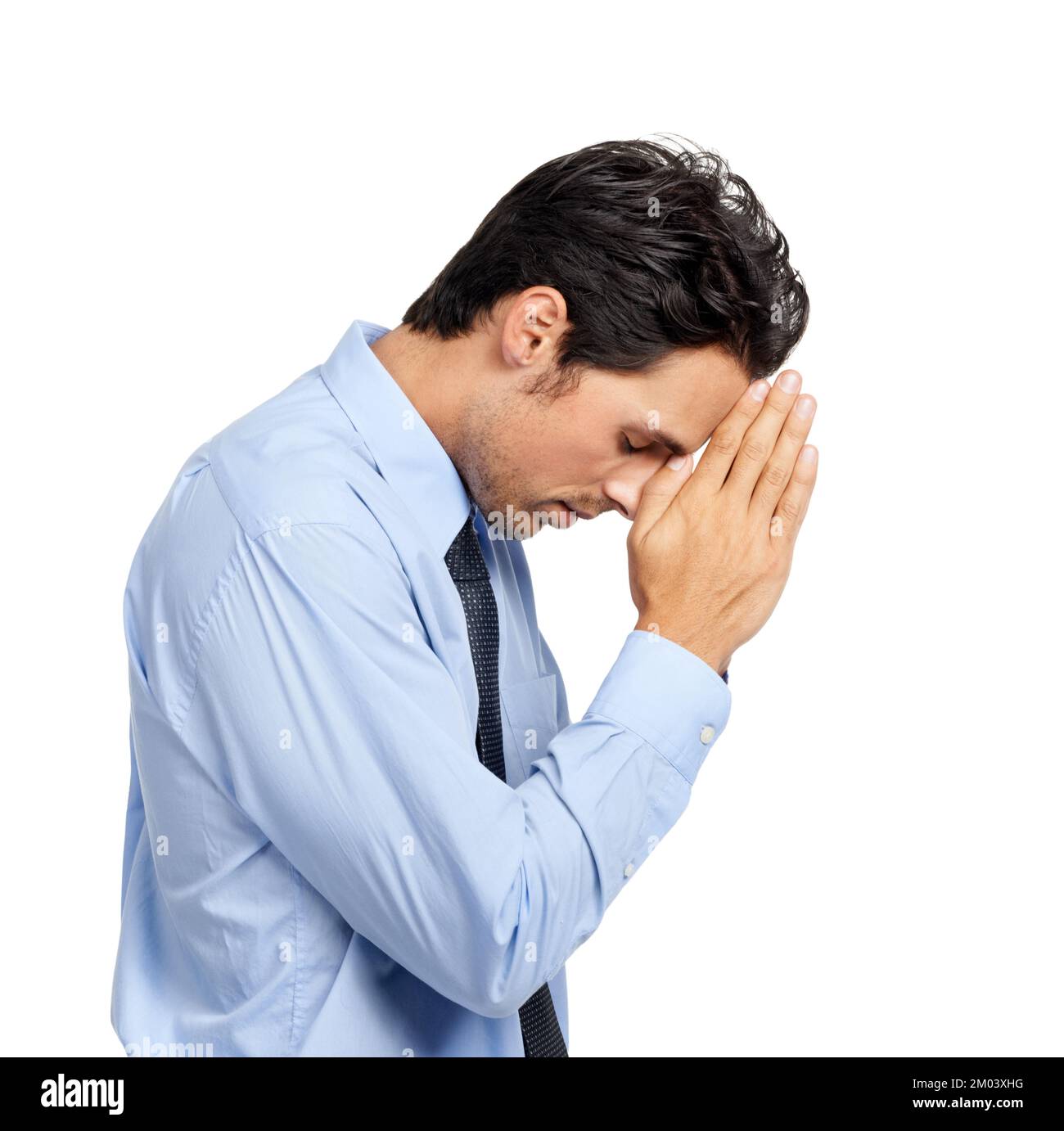 Praying for a miracle - Corporate troubles. A young businessman saying ...