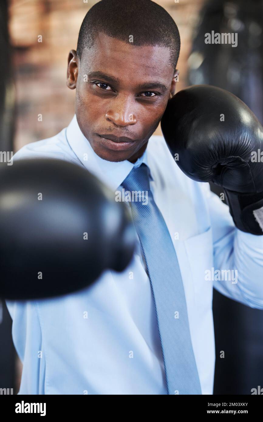 The business world is a harsh place. A young african american boxer in ...
