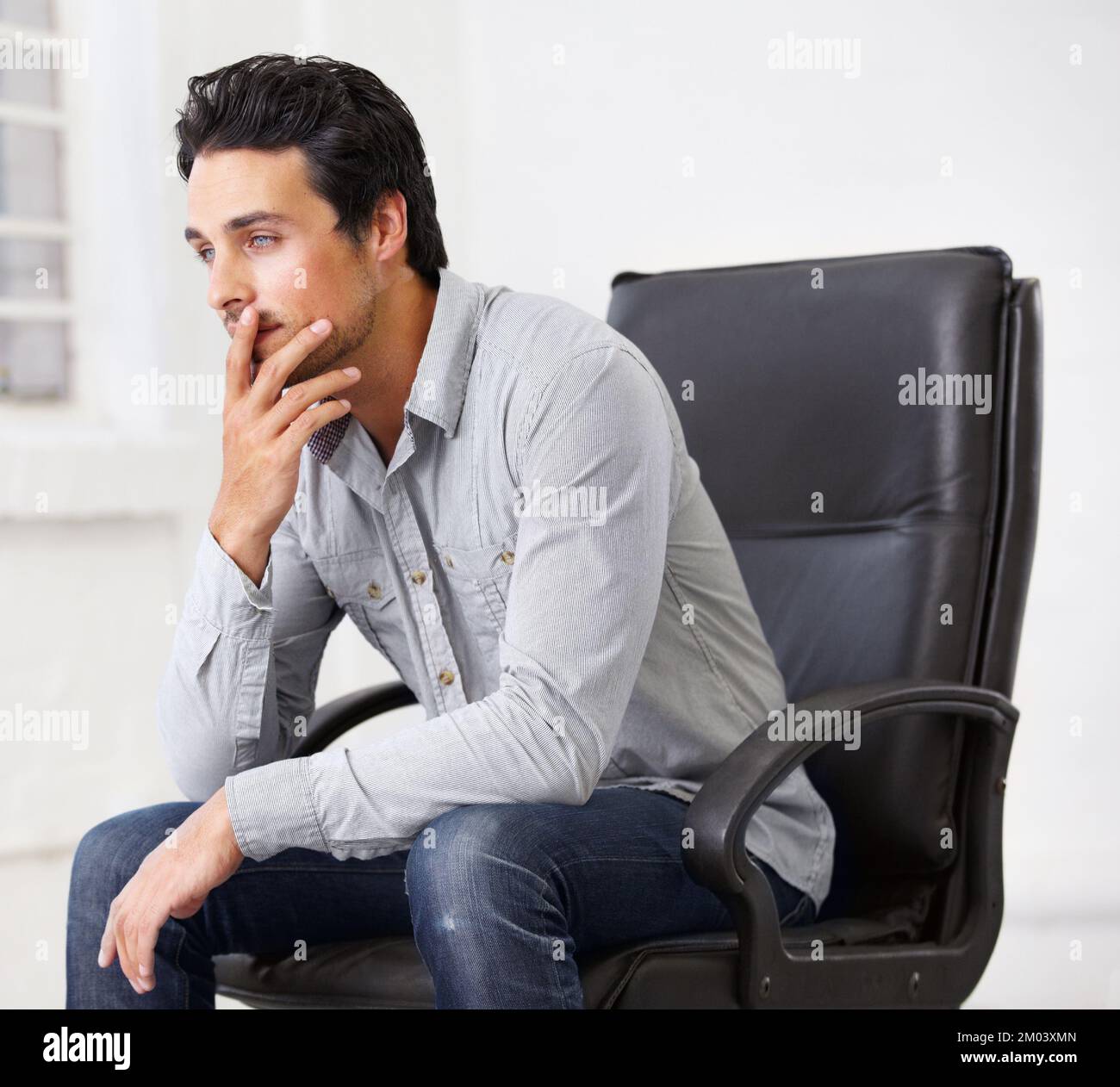 Something is weighing heavily on his mind. a handsome young sitting in ...