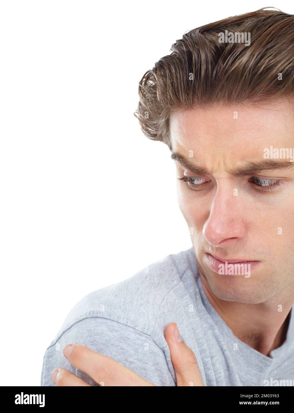 He has a chip on his shoulder. Unimpressed young man looking over his ...