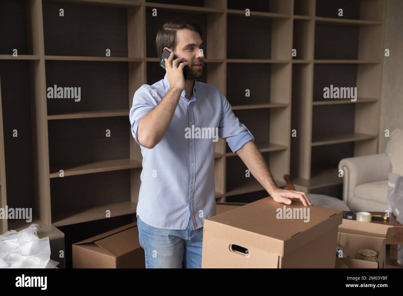 Happy renter man, apartment buyer talking on mobile phone Stock Photo ...
