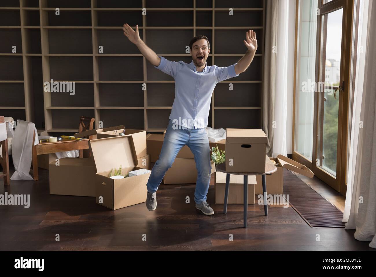 Cheerful excited crazy guy dancing at paper boxes Stock Photo - Alamy