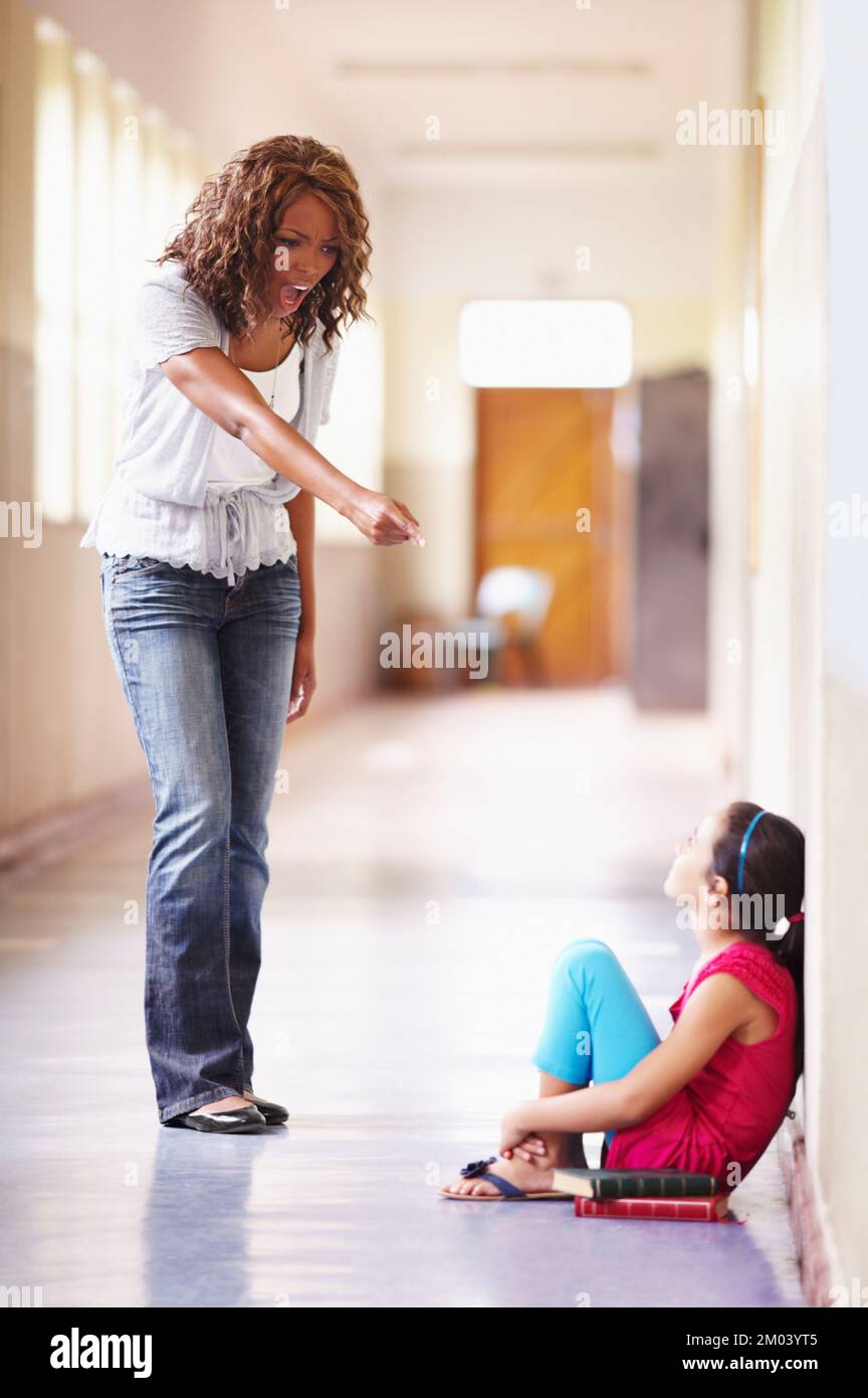 Scolding her for bad behaviour. A teacher scolding a young girl in the ...