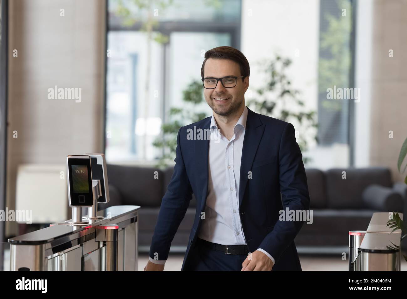 Office employee going through security gates, smile look at camera ...