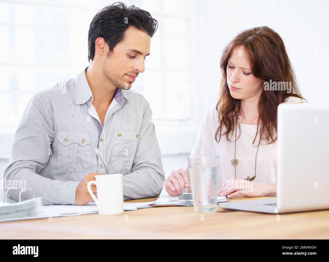 Coworkers making decisions. a two young design professionals sitting ...
