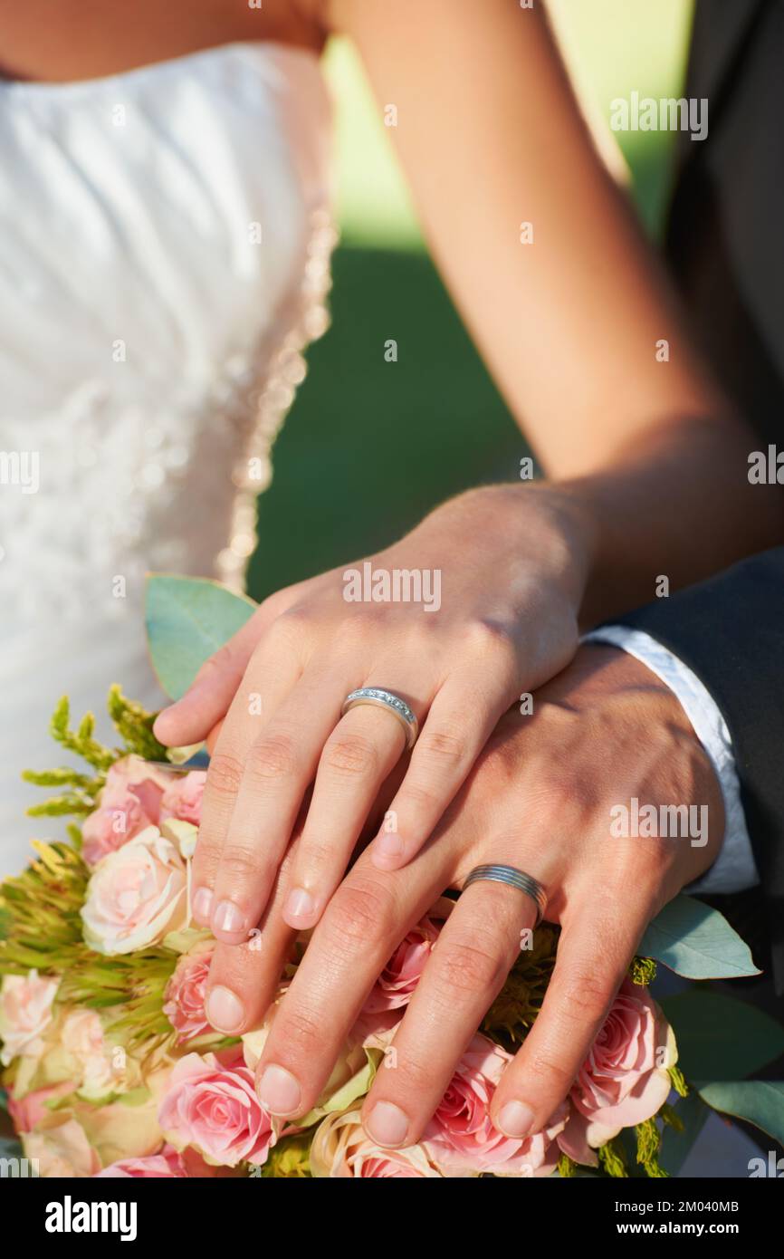 The symbols of eternity. Closeup of a bride placing her hand on her ...