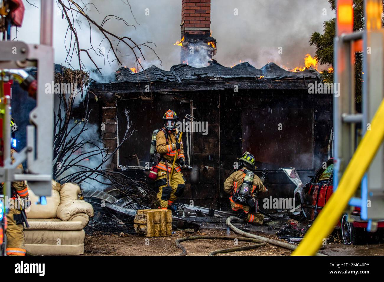 Firefighters working on a structure fire. Two unoccupied homes burned ...