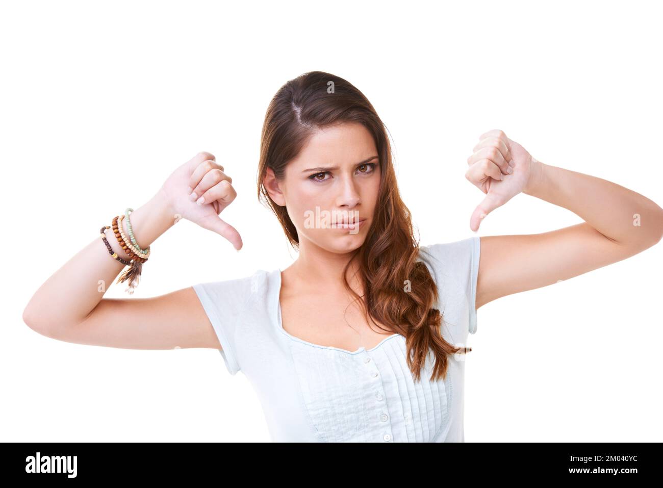 Boo. A beautiful young woman giving you the thumbs down Stock Photo - Alamy