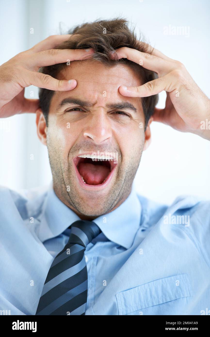 Hes out of his mind. Portrait of a young businessman shouting with ...