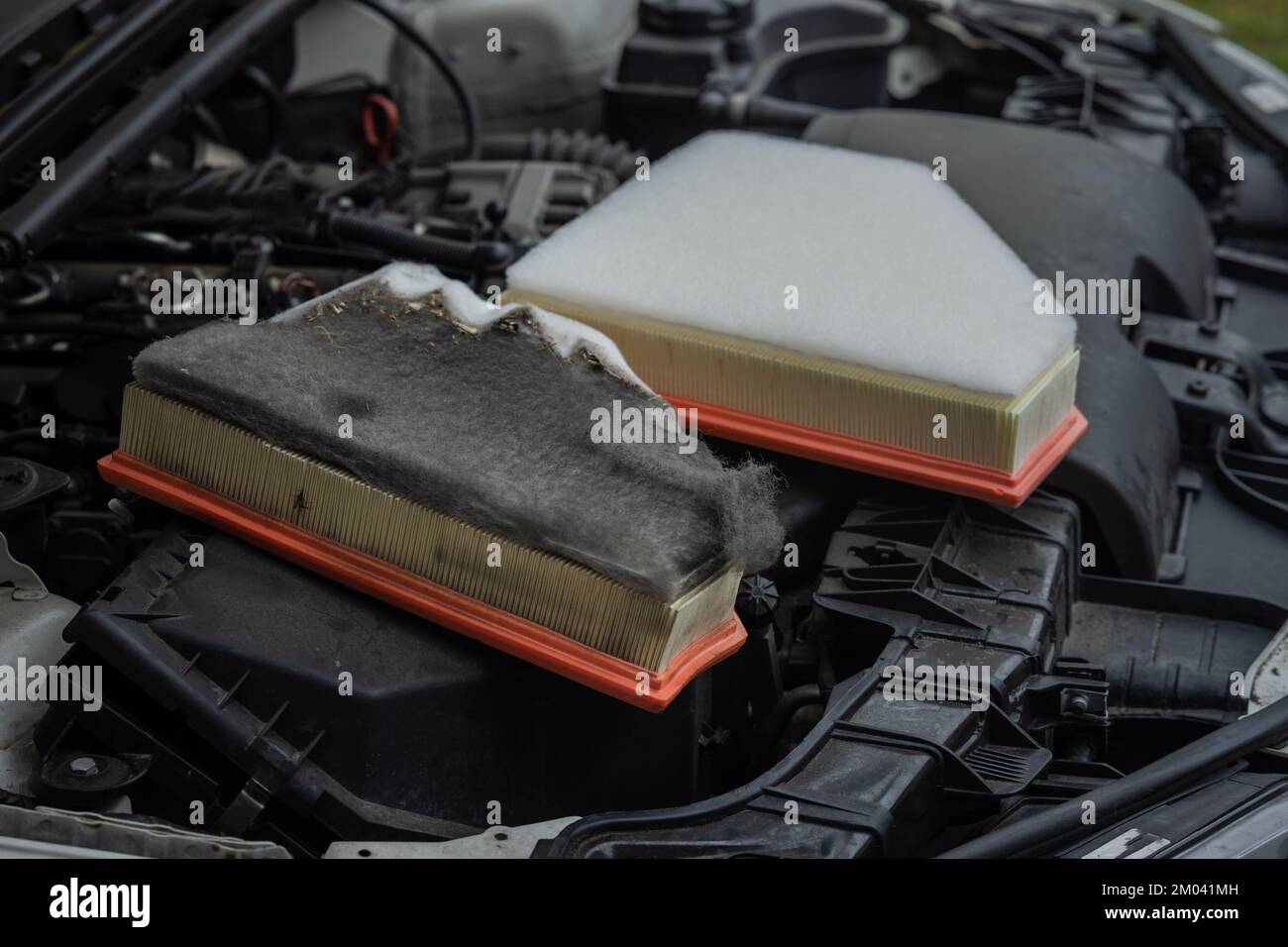 Side by side view of old and new air filter of modern car engine ...