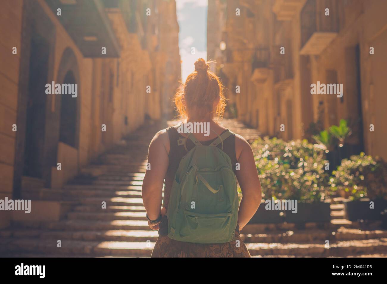 Female solo backpacker on the picturesque narrow streets of Valletta ...