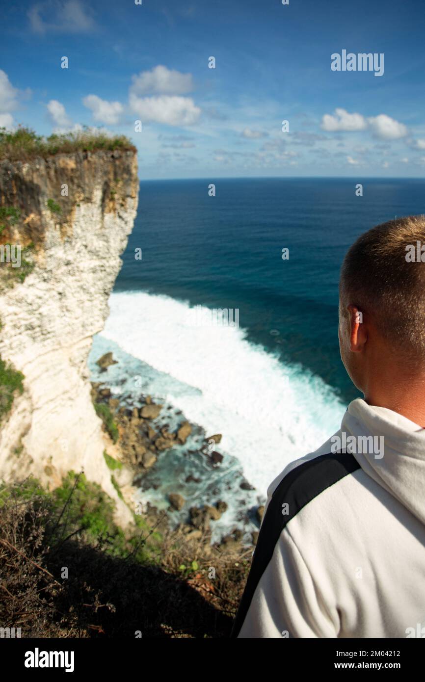 a man stands on a cliff. bali Stock Photo - Alamy