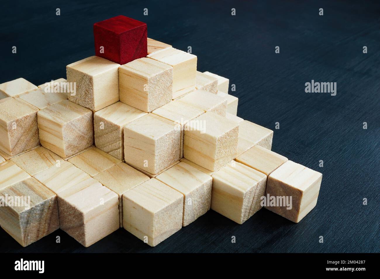Stacked cubes and red on top. Hierarchy, career and leadership concept ...