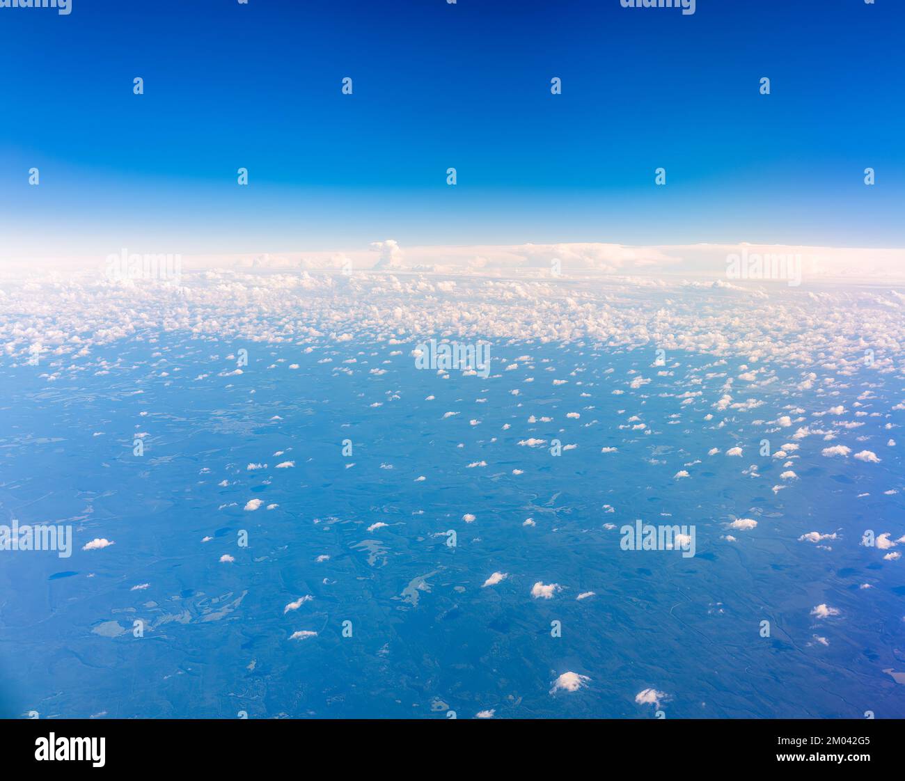 Aerial view from airplane window above green ground. View from the ...