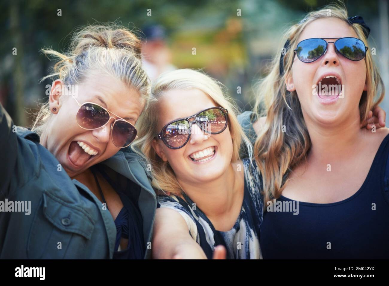 Scream if you love it. Three young friends rocking out to a band at a ...