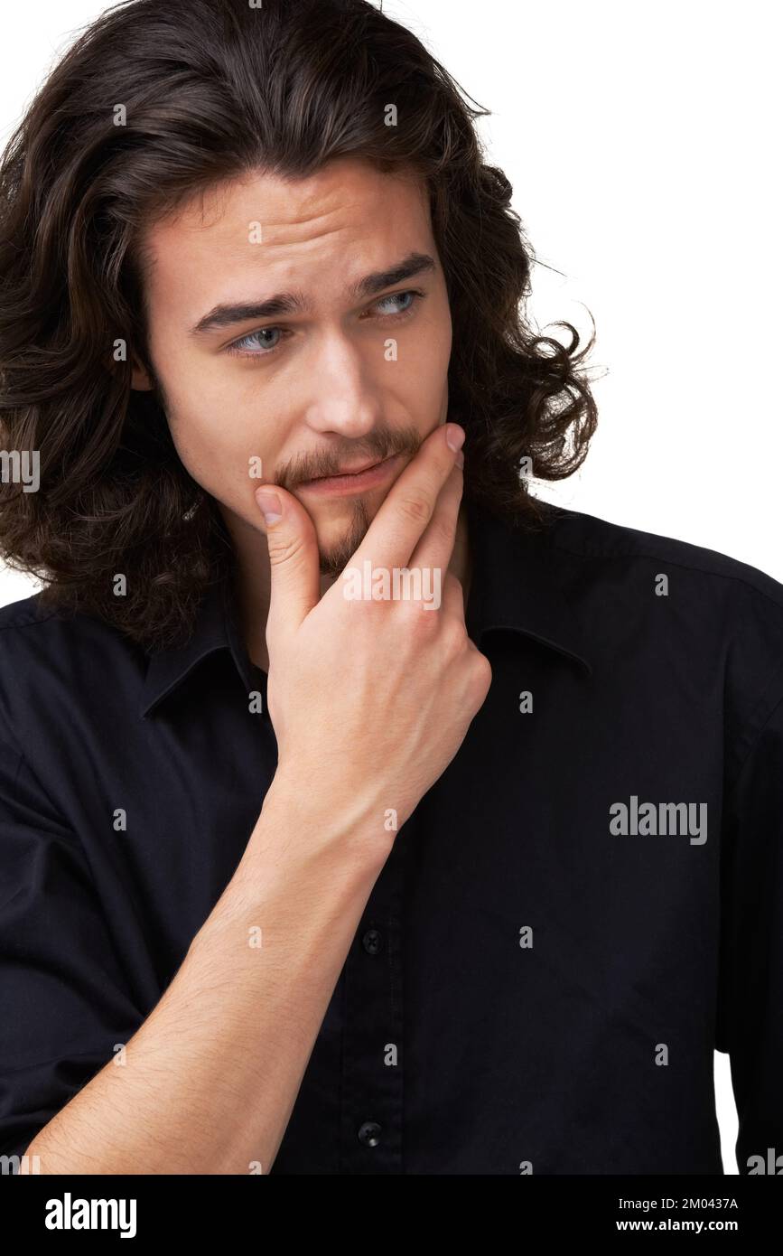 Considering his options. Handsome young man looking thoughtfully ...