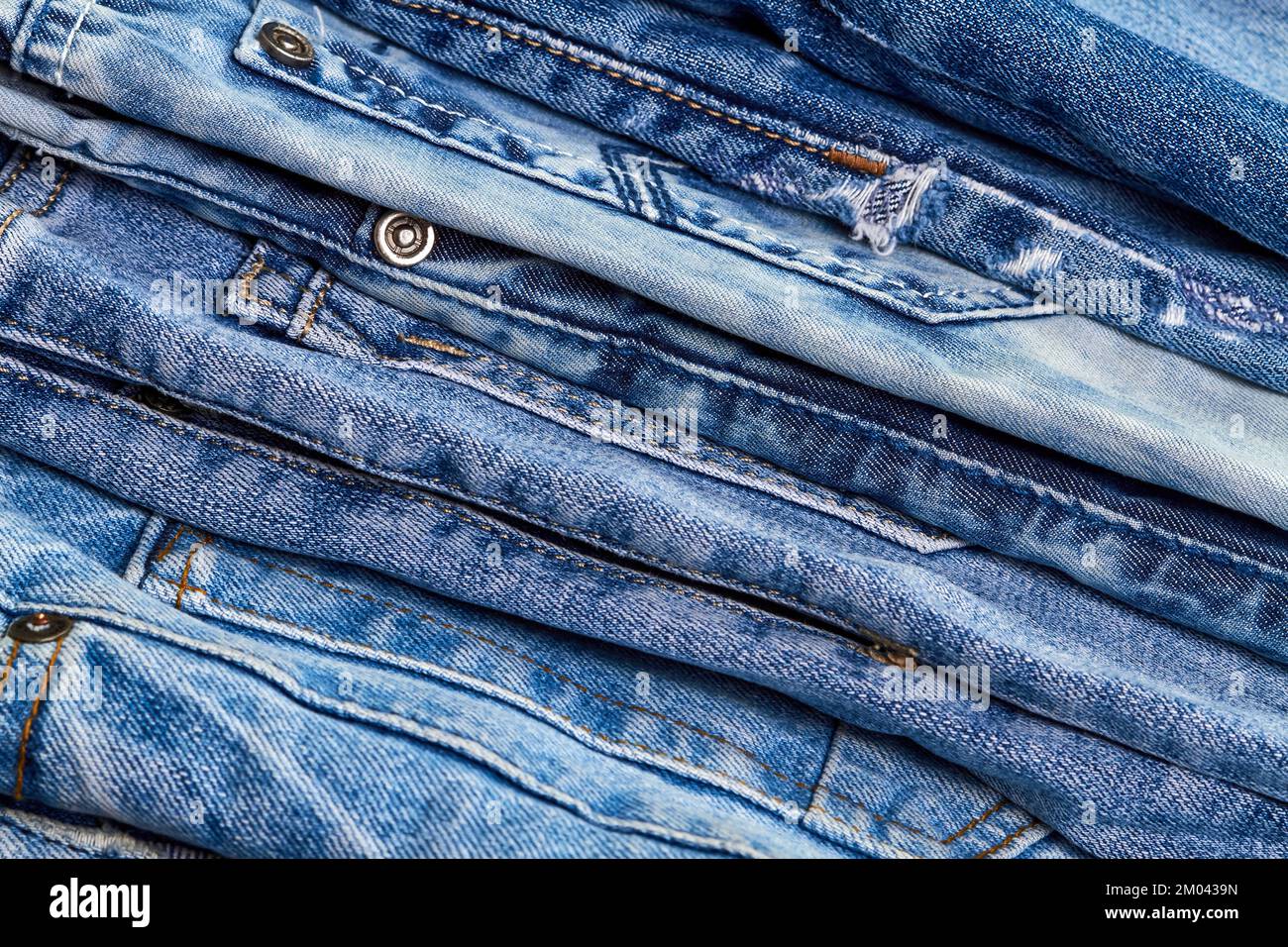 A stack of jeans as denim background or concept of buying, selling ...