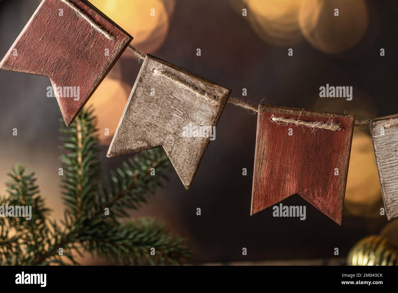 Wooden handmade garland of flags for fir tree. Cozy winter christmas ...