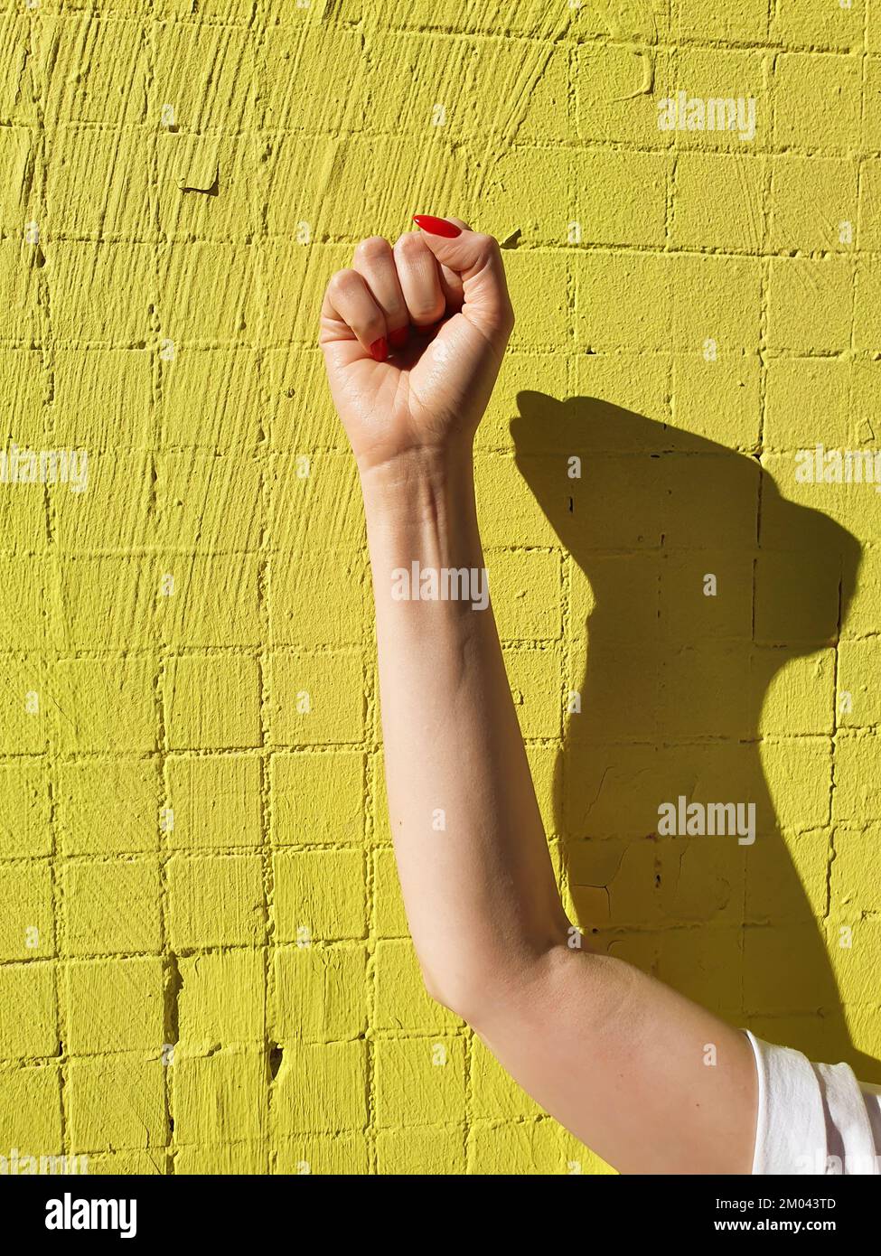 Woman female fist hand with red nails, fist punch air with shadow on ...