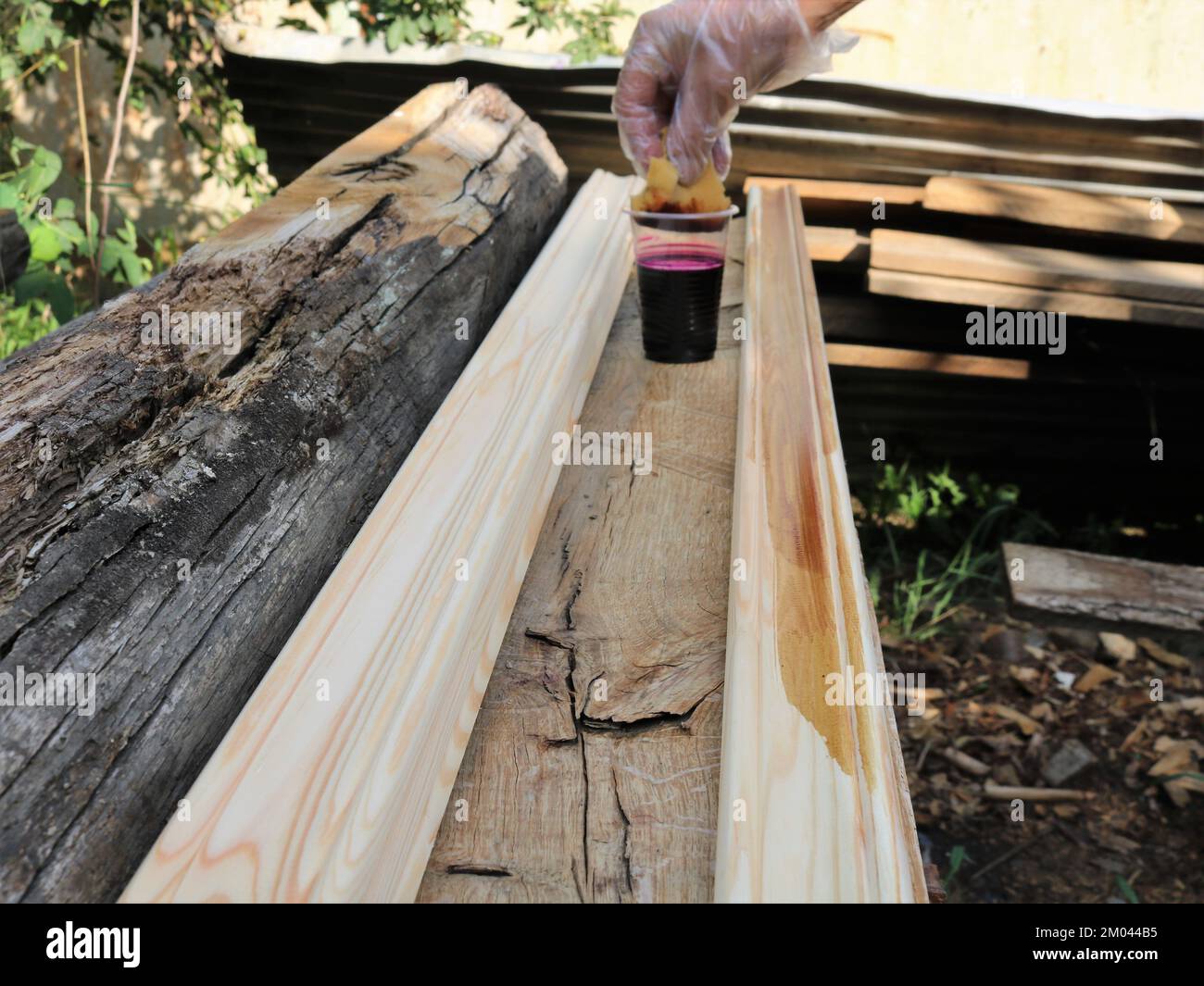 light wooden narrow planks at the outdoor workplace of a carpenter and ...