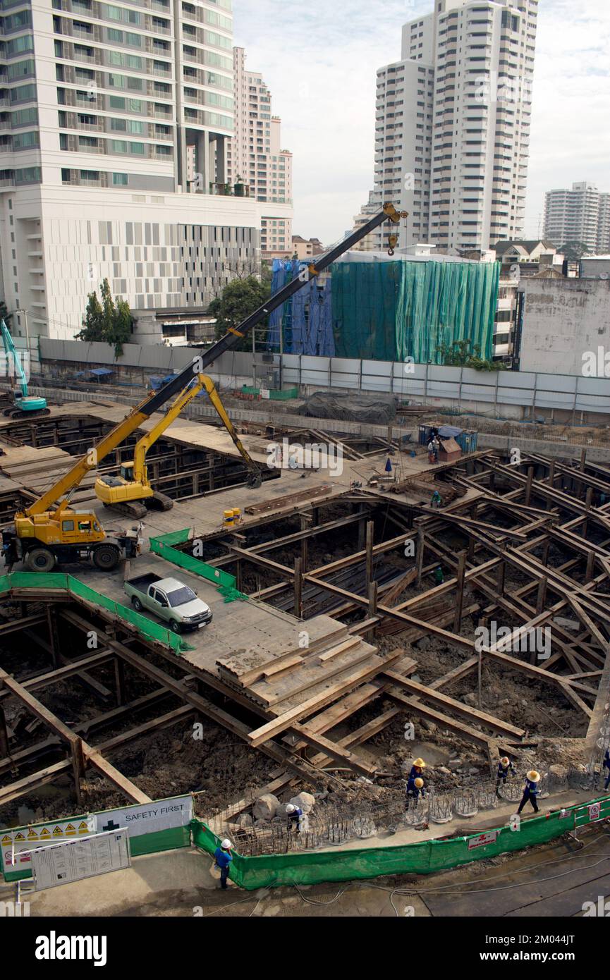 Workers work at the construction site and machines are laying the ...