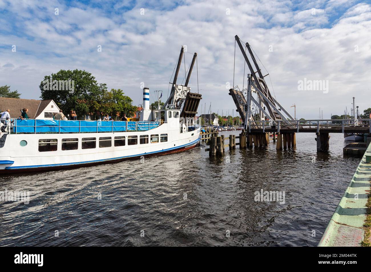 Excursion boat passing through open drawbridge, double balance beam ...